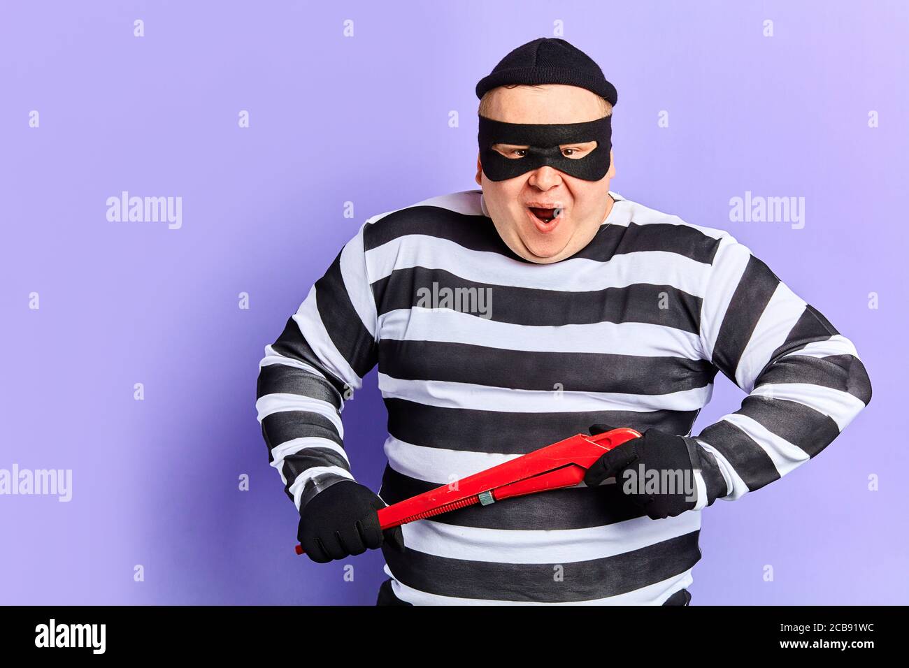 excited happy criminal looking forward to blowing open safe, bank ...