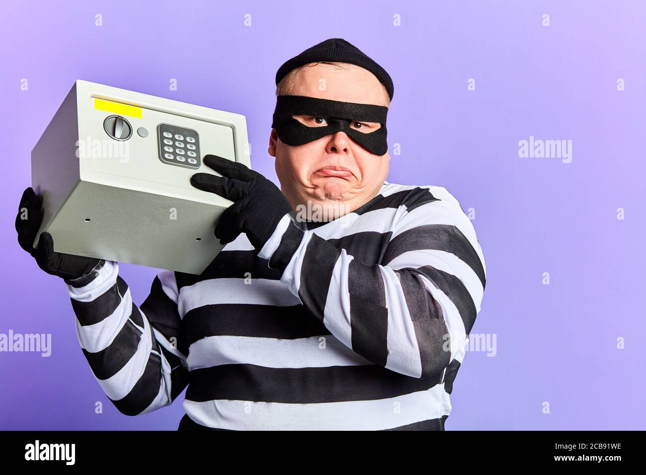 unhappy sad thief cannot open the safe. close up portrait. isolated ...