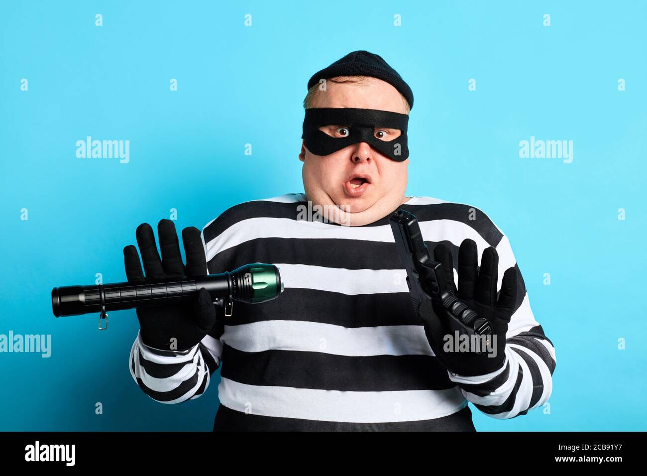 scared burglar doesn't want tobe caught by policeman, isolated blue ...