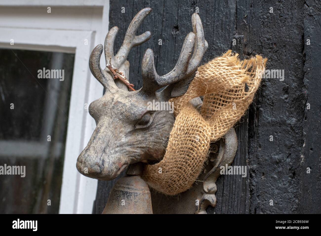 Closeup shot of deer's head statue with bell Stock Photo - Alamy