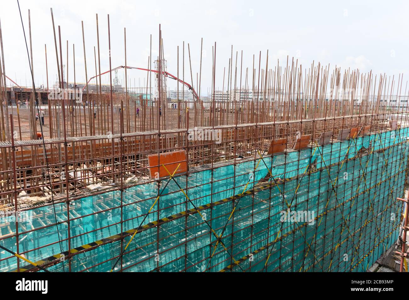 outside of an unfinished building with protection scaffolding and ...