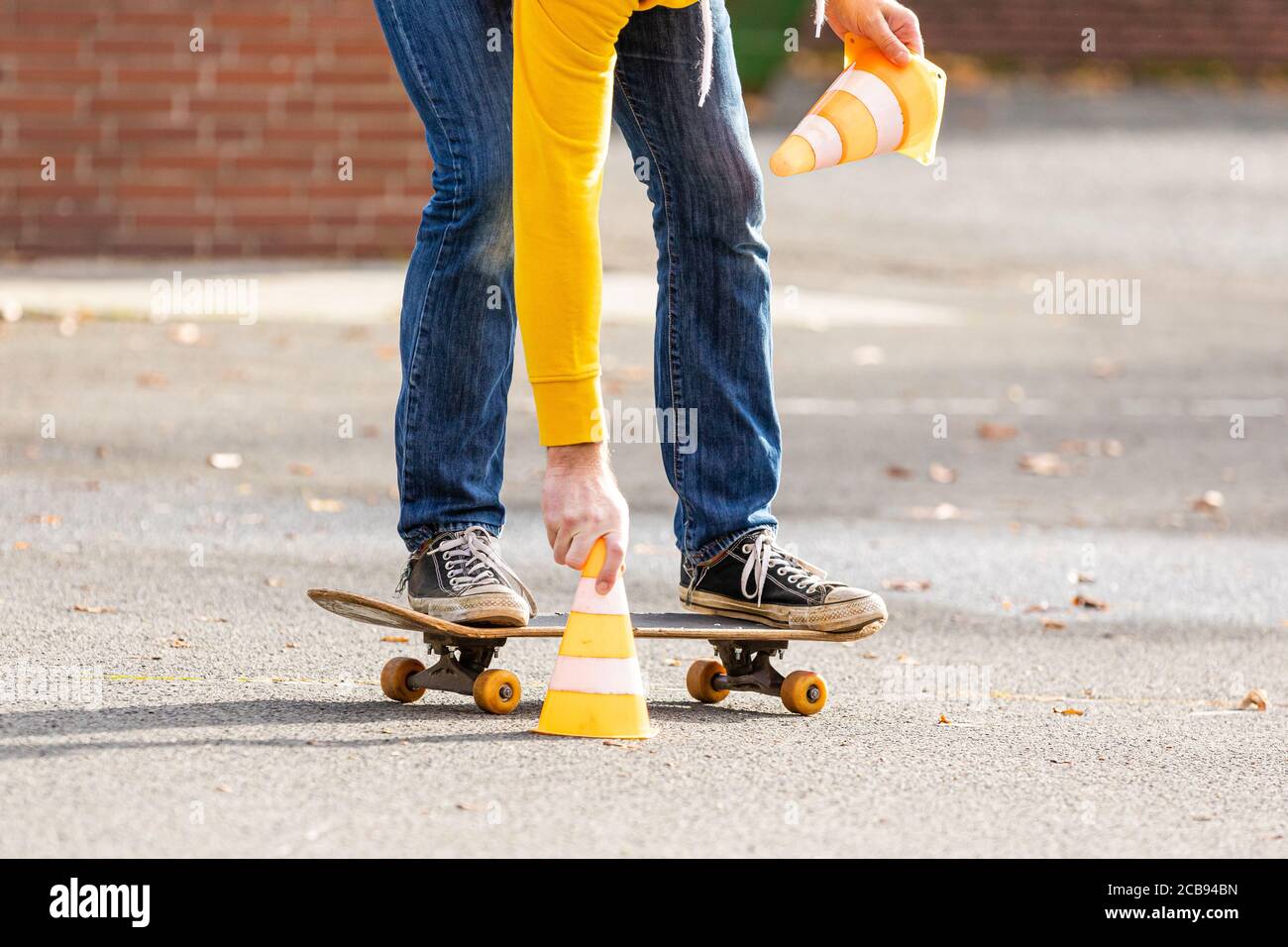 Person placing cones on the ground while riding a skateboard Stock ...