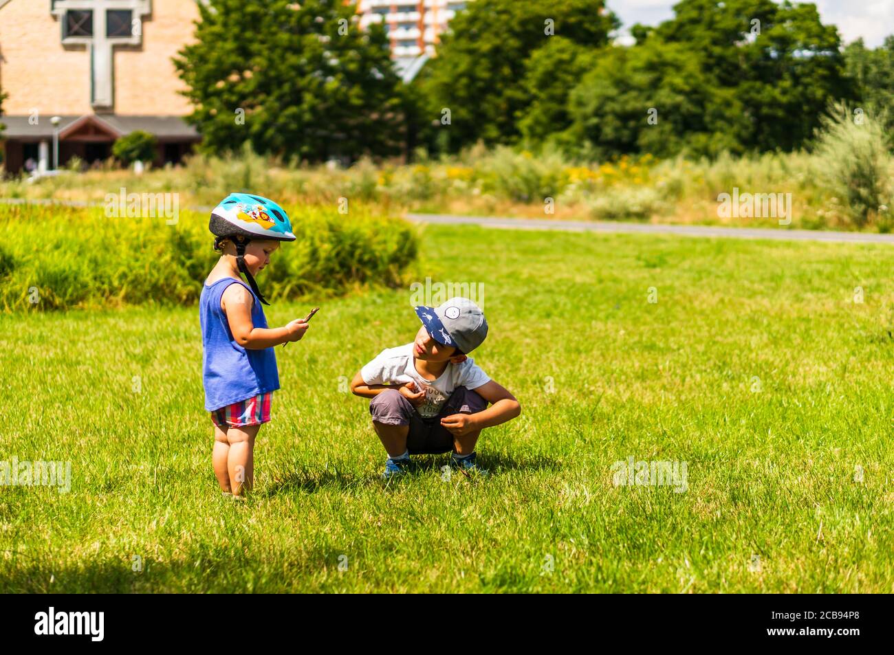 Girl showing something to a boy hi-res stock photography and images - Alamy