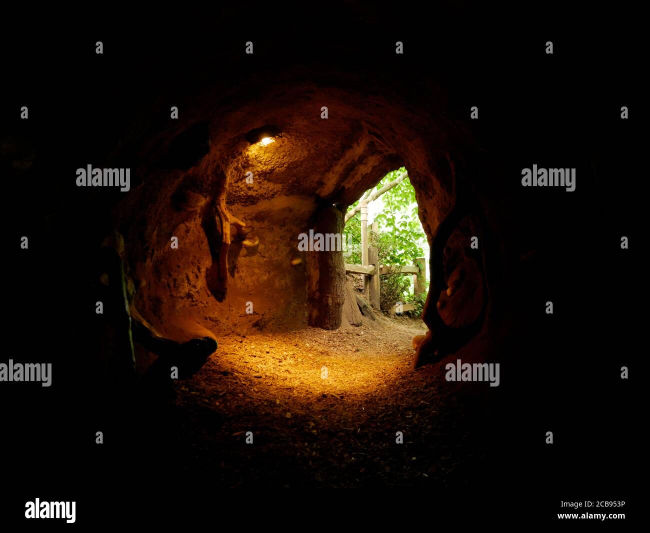 Shot of the exit of a dark cave Stock Photo - Alamy