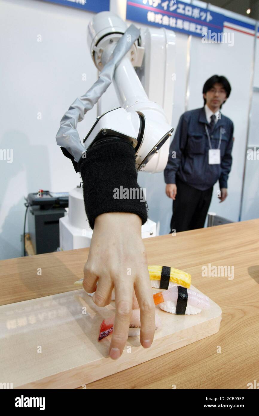 A robot cooks sushi during a demonstration at the FOOMA Japan ...