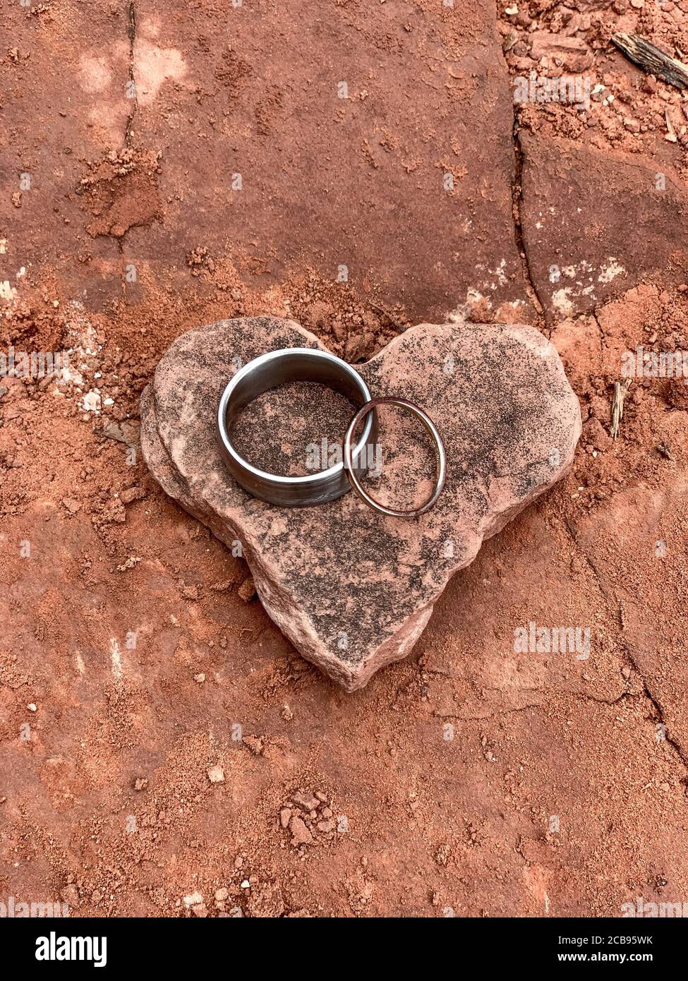 Wedding rings on love heart shaped rock Stock Photo - Alamy