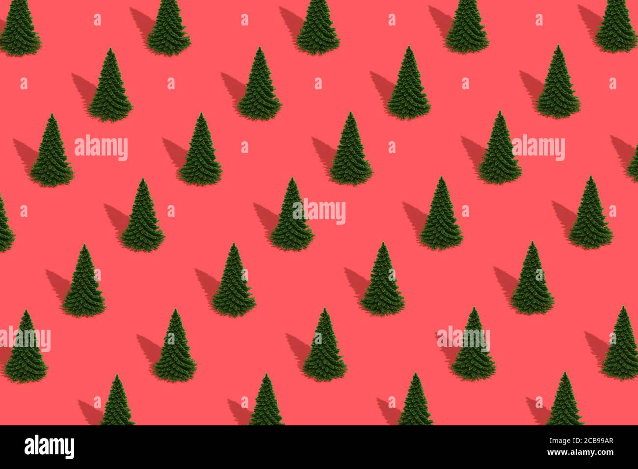 Pattern from Christmas trees on red background. New Year concept ...