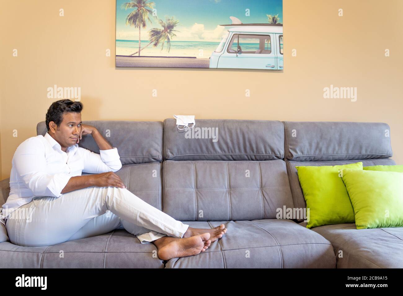 Teleworking man sitting on the couch at home. Laptop and mobile ...