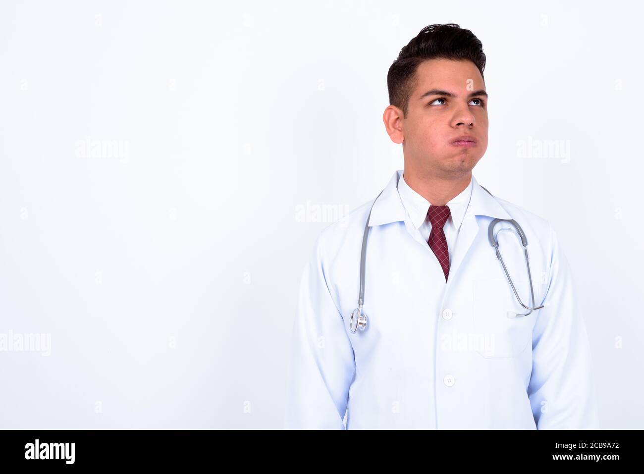 Portrait of young handsome multi ethnic man doctor Stock Photo - Alamy