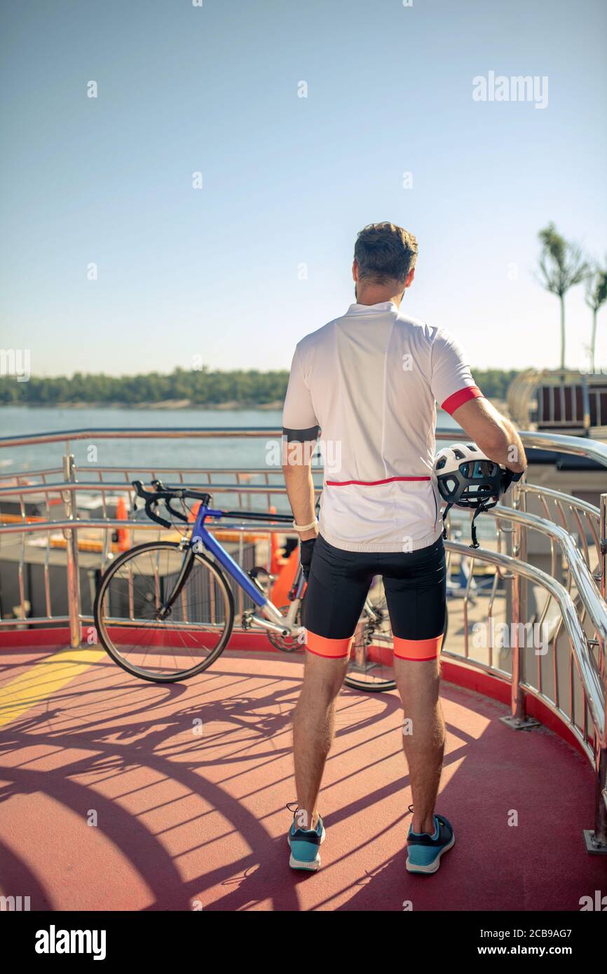 Man looking back cycling hi-res stock photography and images - Alamy