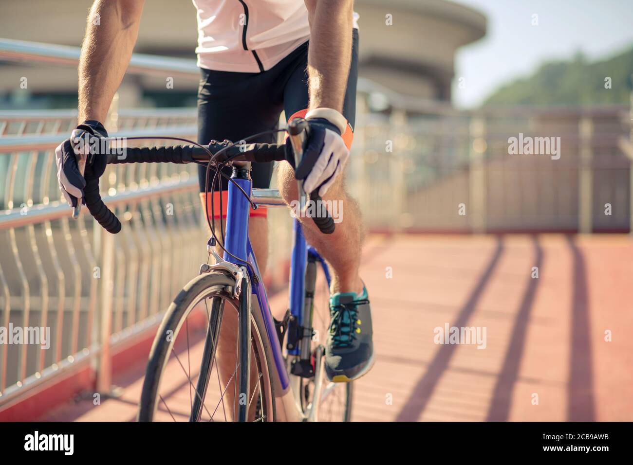 Cyclist feet pedaling a bicycle on bridge Stock Photo - Alamy