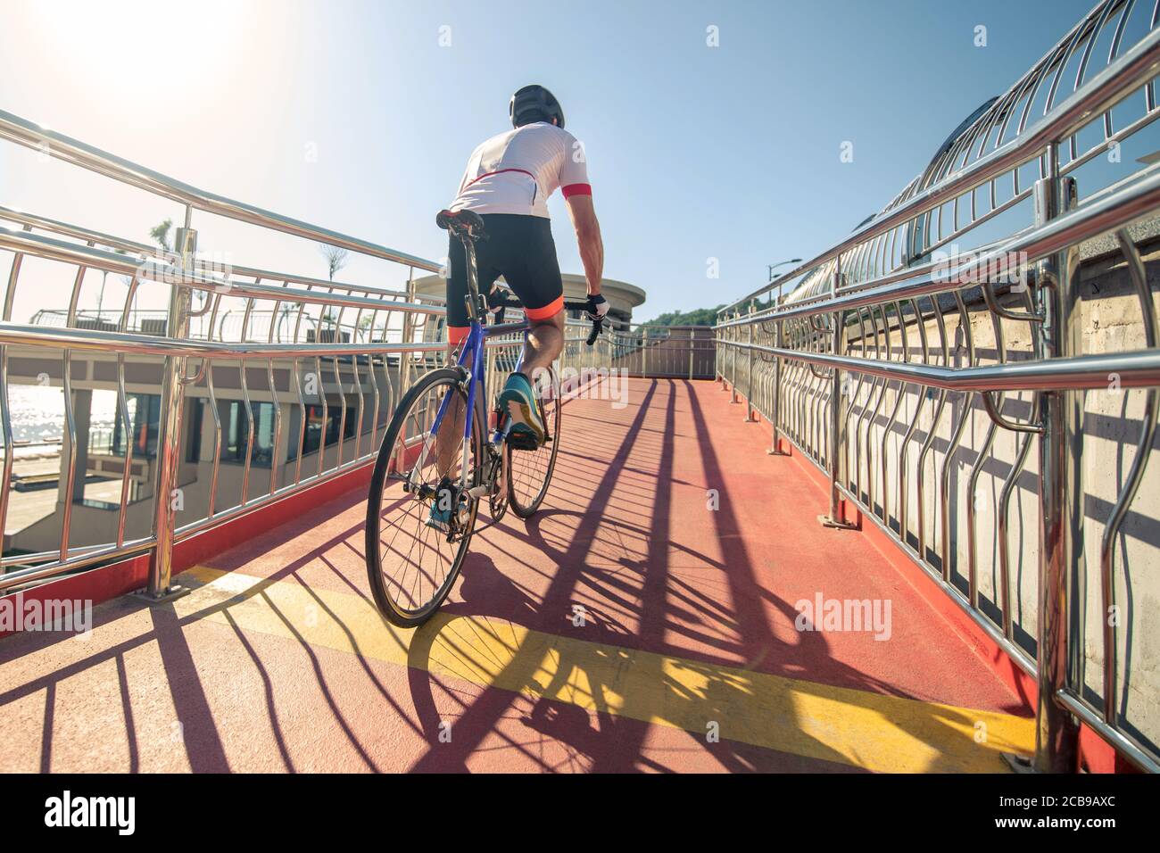 Cyclist on the bridge from the back Stock Photo - Alamy