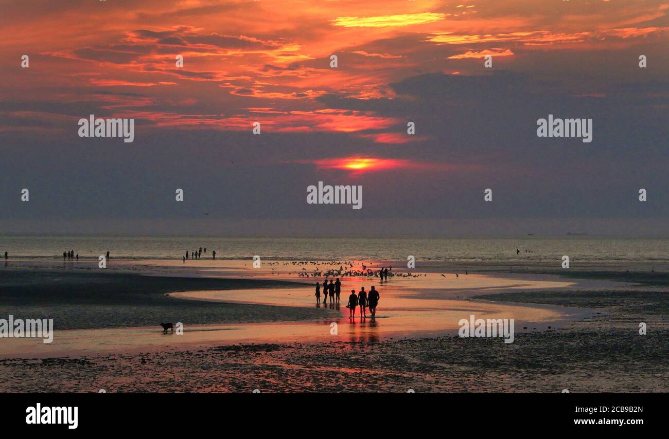 Heacham, UK. 10th Aug, 2020. The end of another hot day as a few people ...