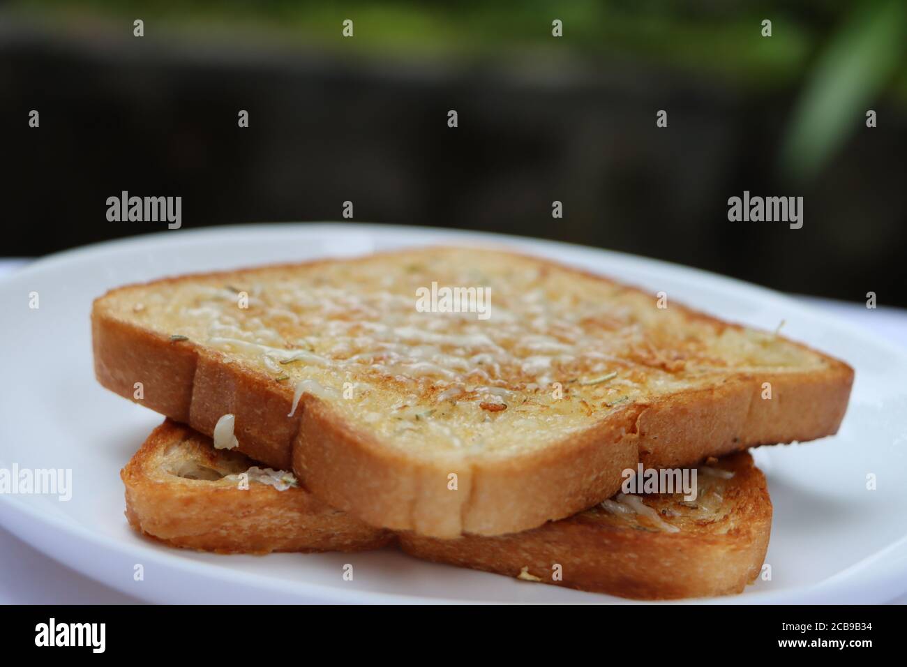 Garlic cheese bread toast, with herbs, morning breakfast Stock Photo ...