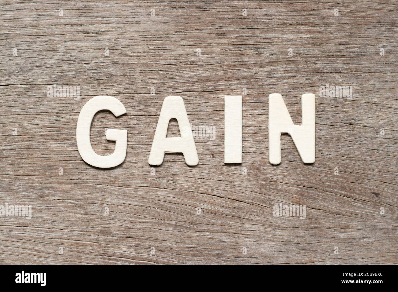 Alphabet letter in word gain on wood background Stock Photo - Alamy
