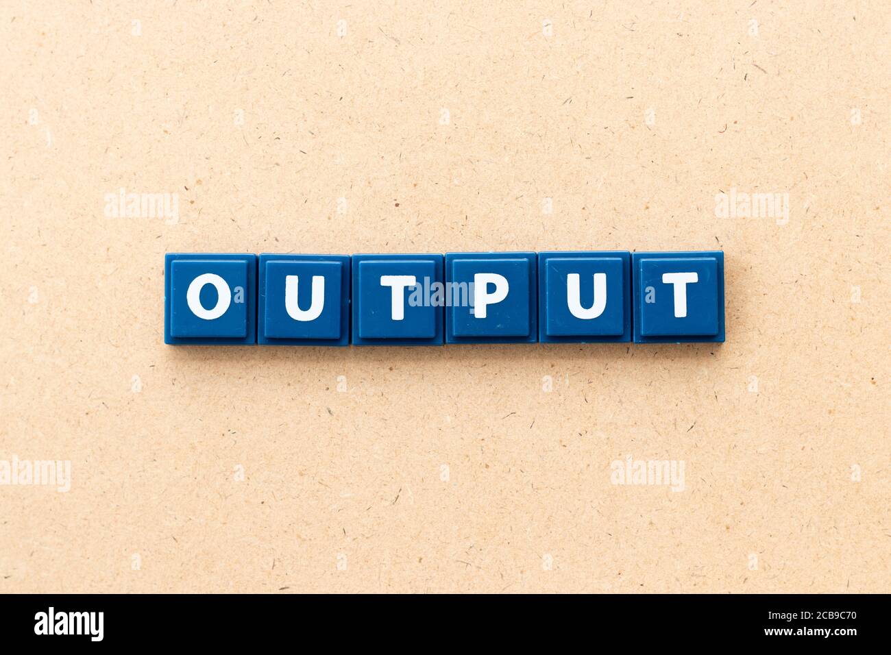 Tile letter in word output on wood background Stock Photo - Alamy