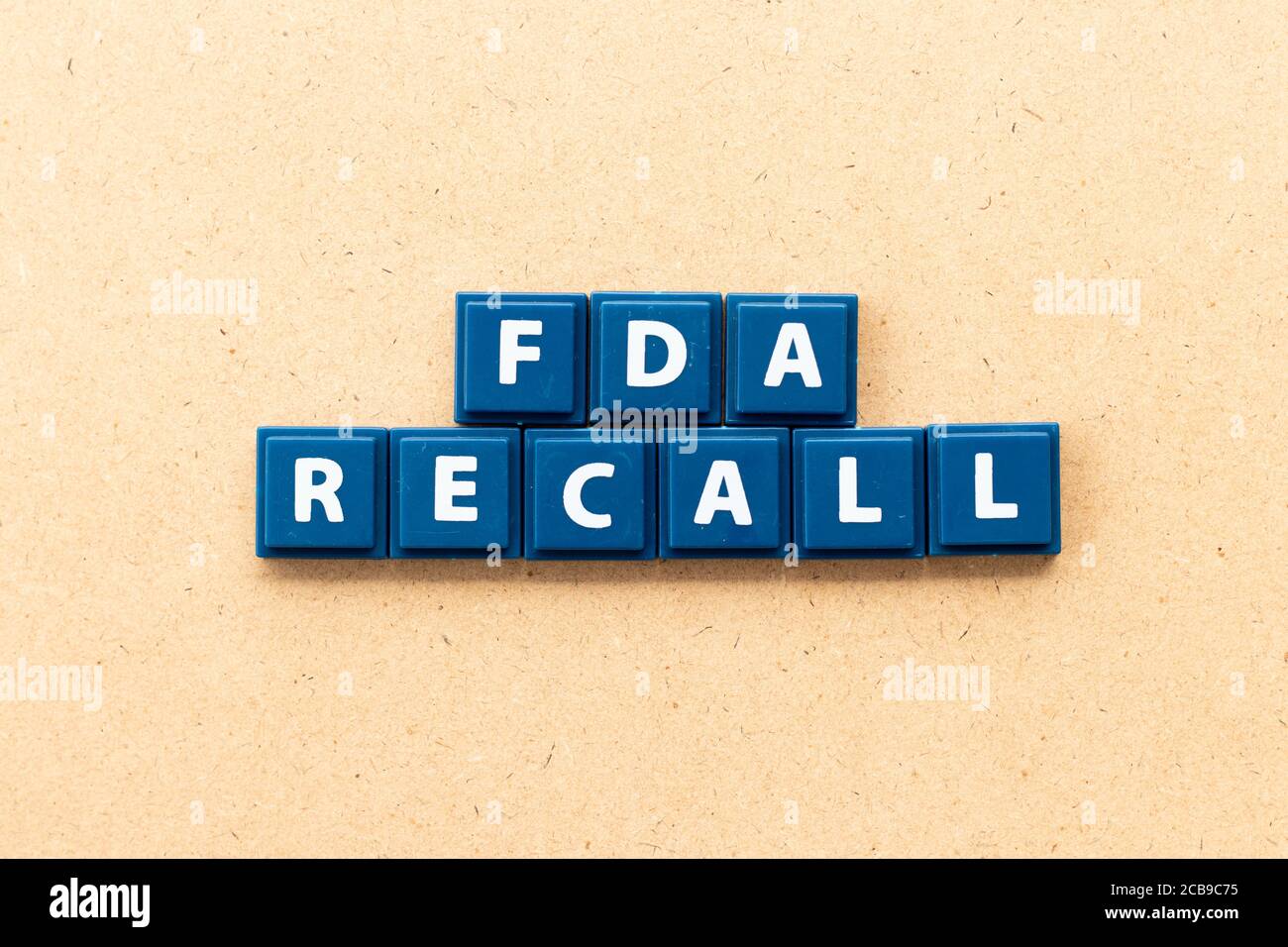 Tile letter in word fda recall on wood background Stock Photo - Alamy