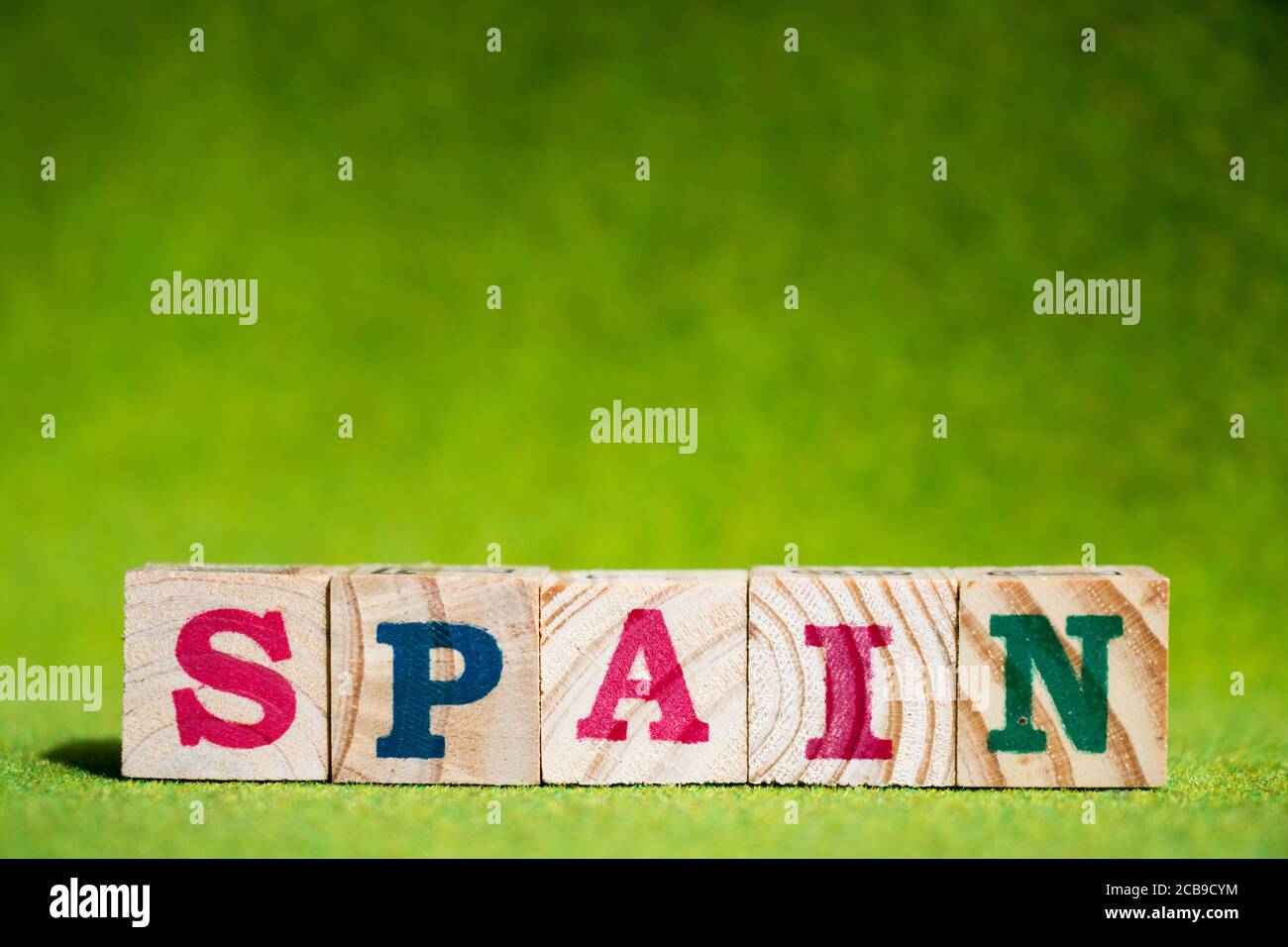 Letter block in word spain on artificial green background Stock Photo ...