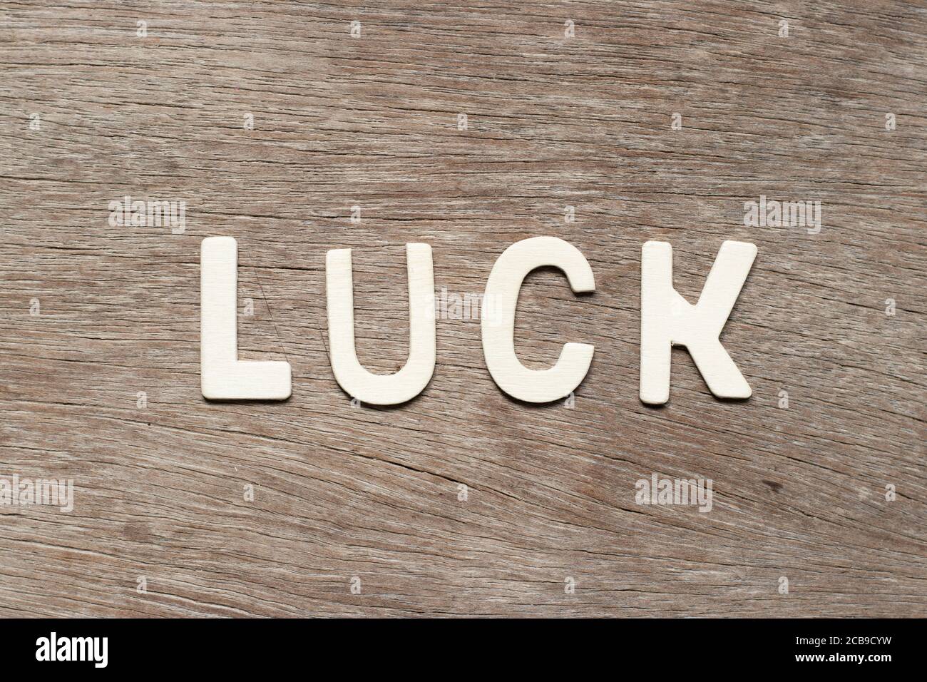Alphabet letter in word luck on wood background Stock Photo - Alamy
