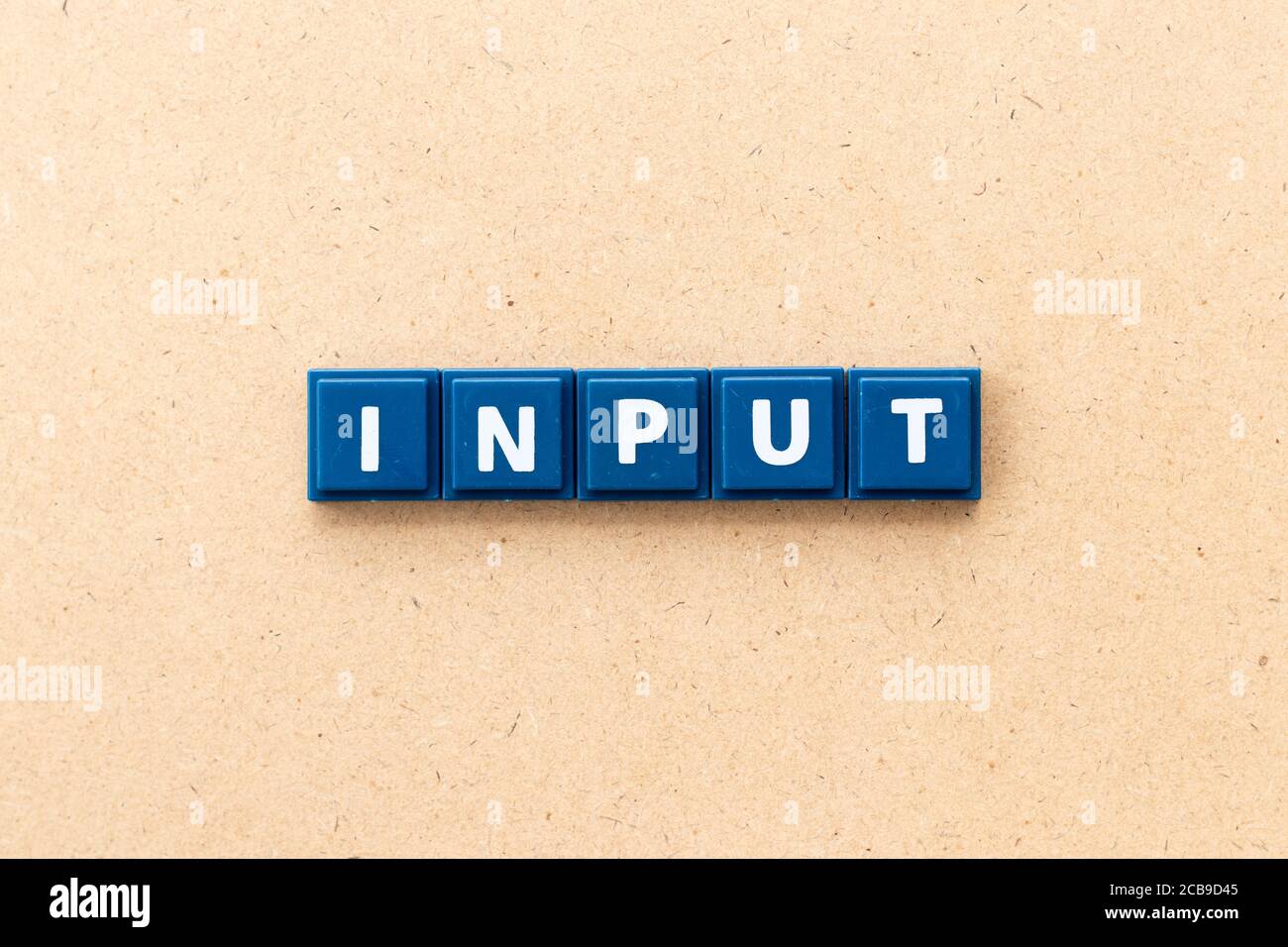 Tile letter in word input on wood background Stock Photo - Alamy