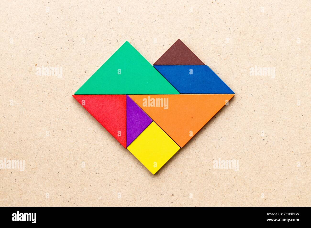 Color tangram puzzle in heart shape on wood background Stock Photo - Alamy