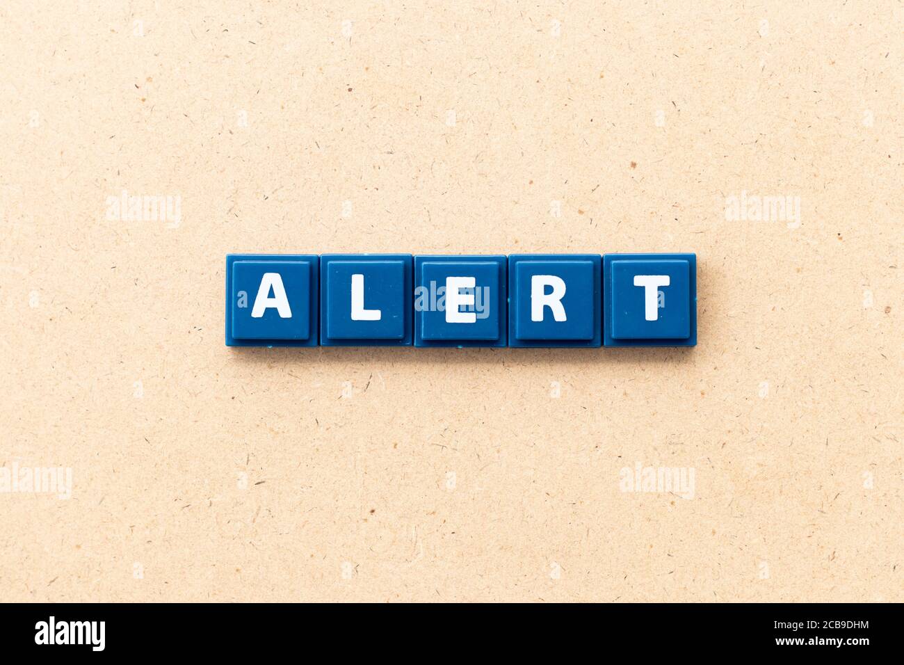 Tile letter in word alert on wood background Stock Photo - Alamy