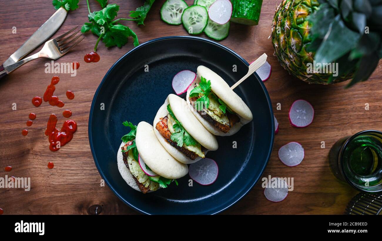 Pork belly steam bun with pickled veggies Stock Photo - Alamy