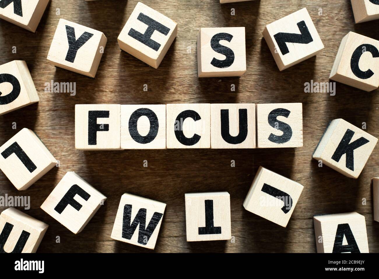 Letter block in word focus with another block on wood background Stock ...
