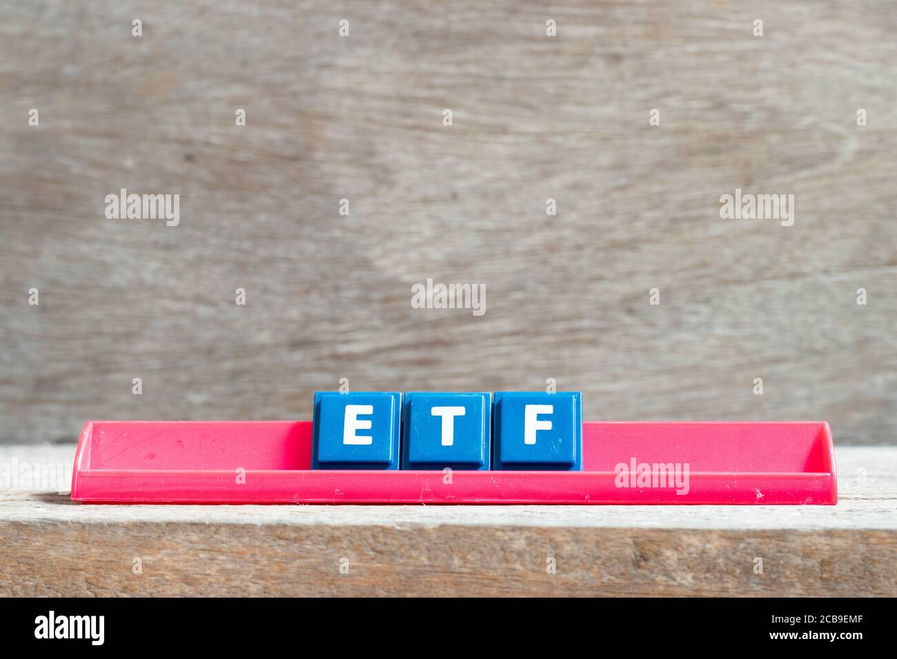 Tile letter on red rack in word ETF (abbreviation of Exchange Traded ...