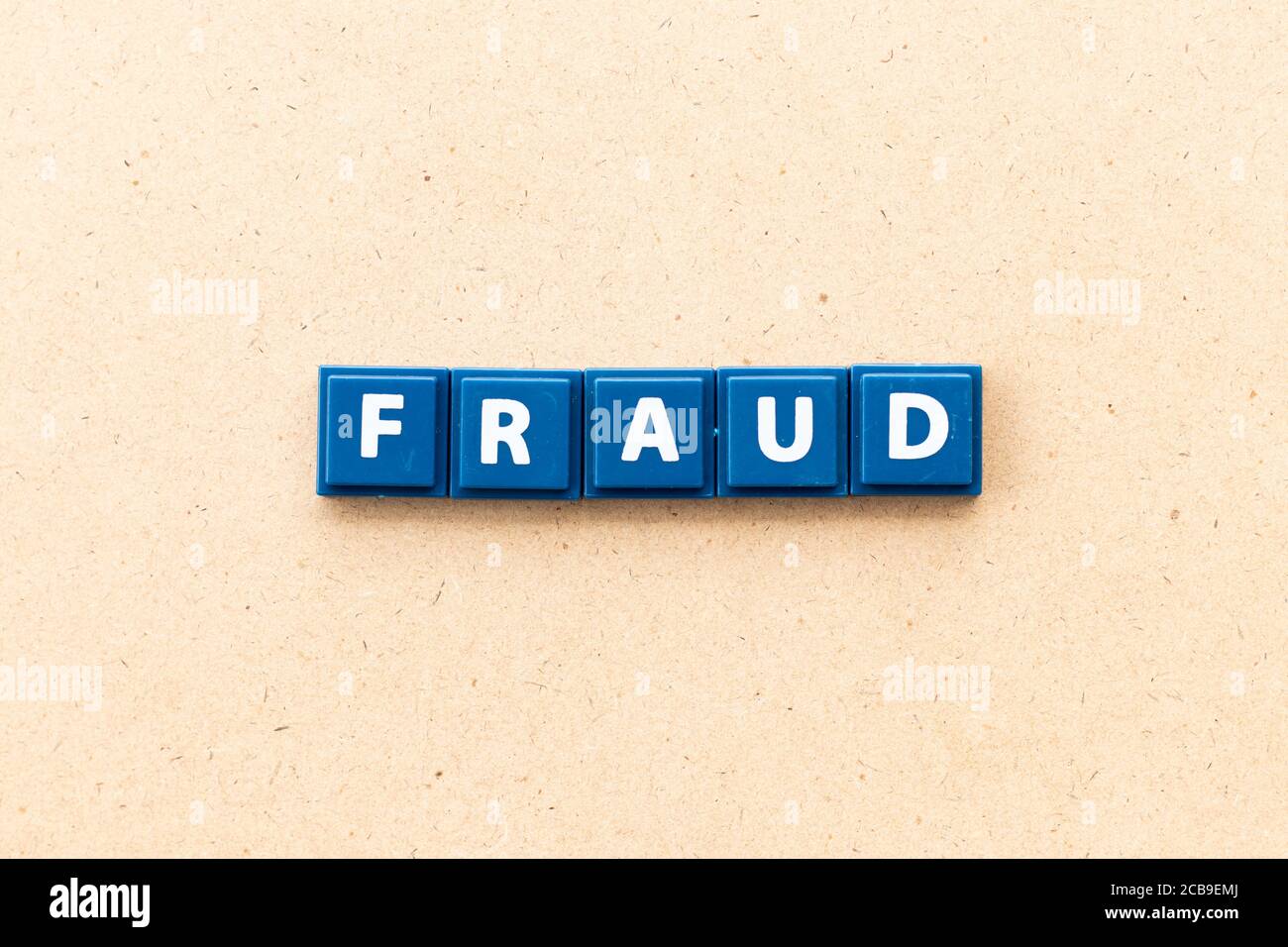 Tile letter in word fraud on wood background Stock Photo - Alamy