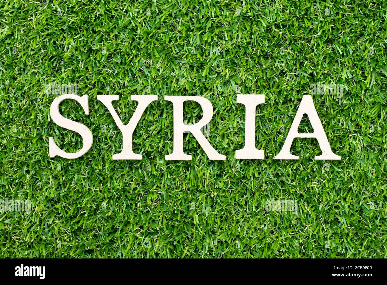 Wood alphabet letter in word Syria on green grass background Stock ...