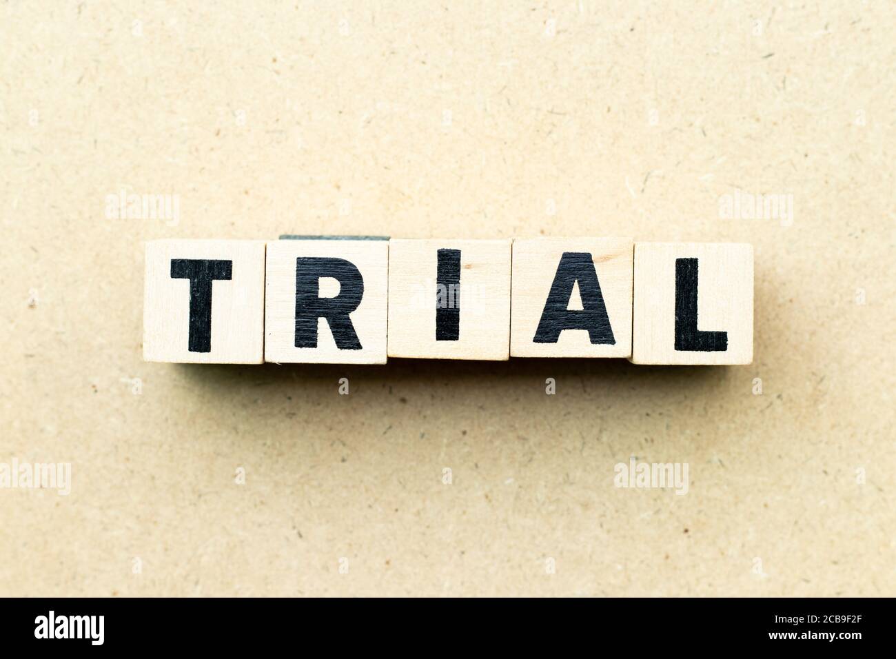 Letter block in word trial on wood background Stock Photo - Alamy