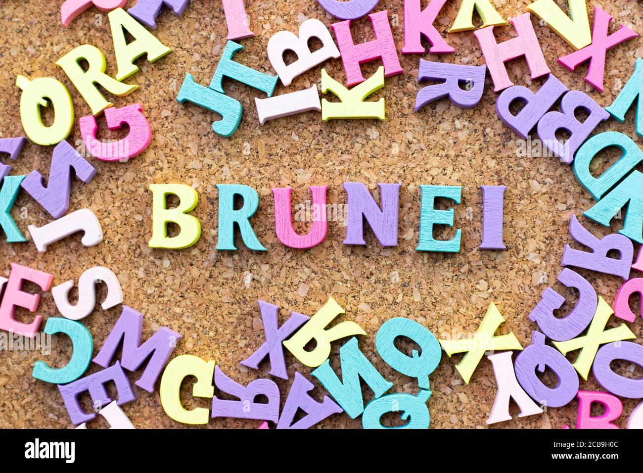Color alphabet in word Brunei with another letter as frame on cork ...