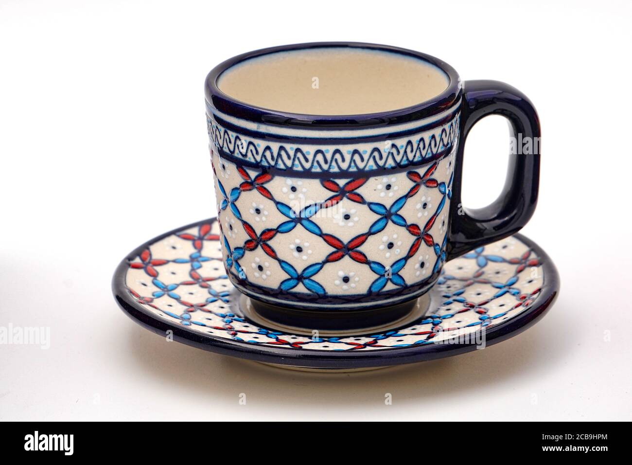 Cup and a plate of coffee with a traditional design with a white ...