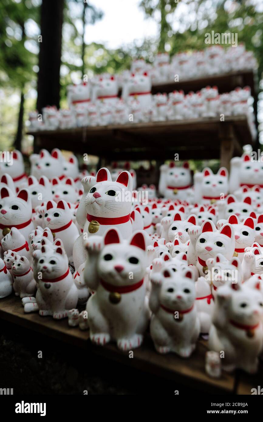 Vertical shot of a Japanese beckoning statue cat Maneki Neko that ...