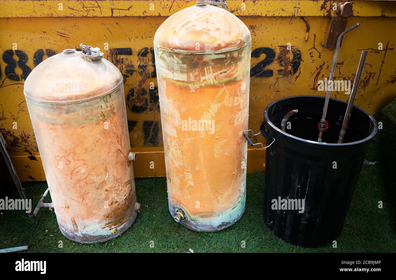 Disused hot water cylinders waiting for recycling Stock Photo - Alamy