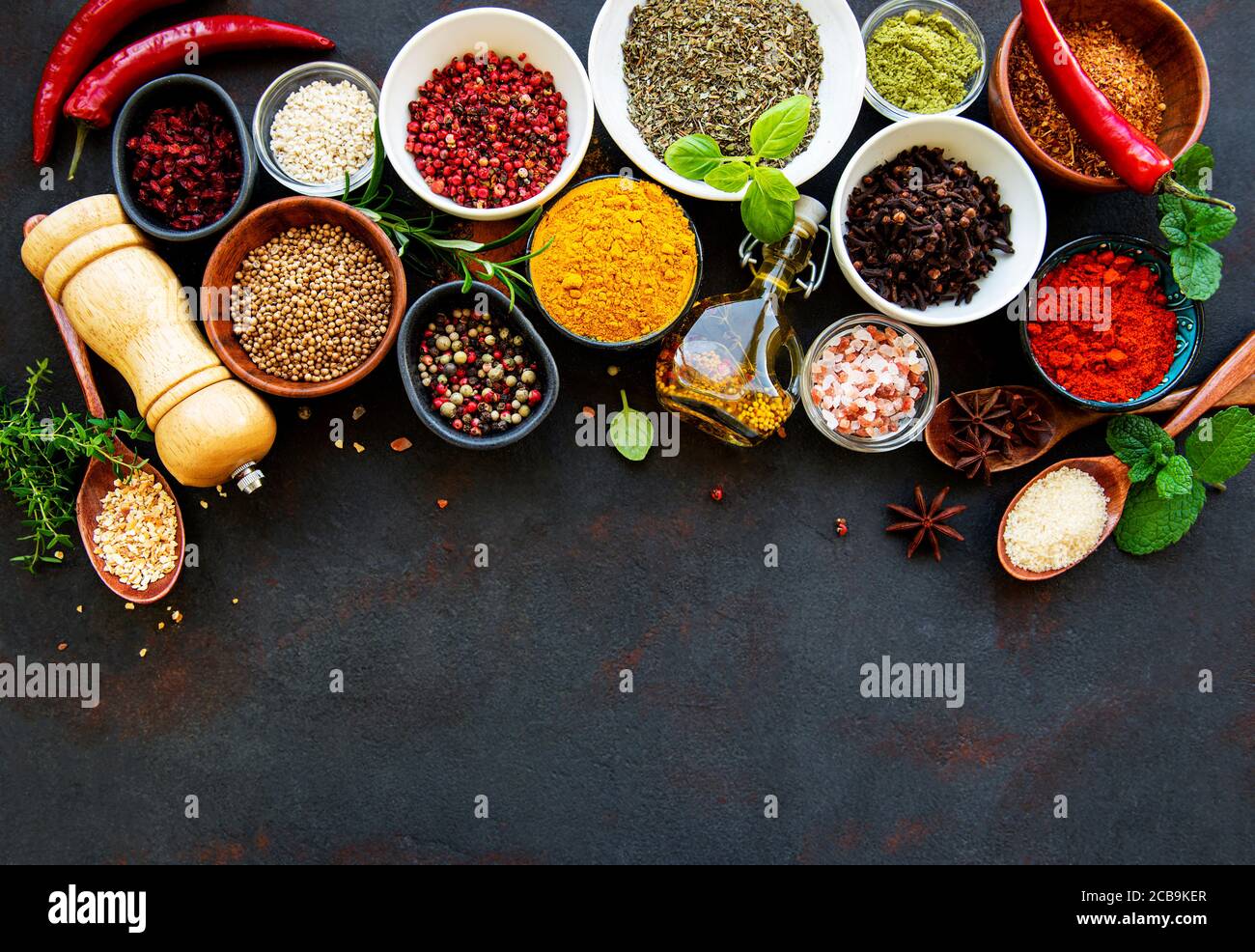 Different assortment of spices on black stone background. Top view ...