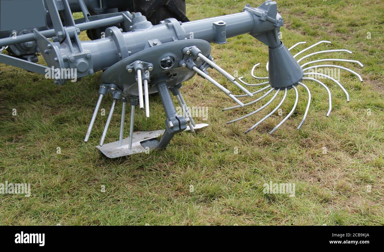 A Hay Cutter and Turner Attached to a Farming Tractor Stock Photo - Alamy