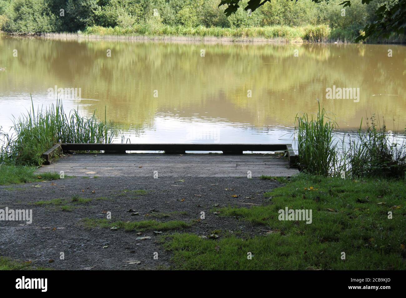 A Wooden Fishing Stage on a Tranquil Lakeside Stock Photo - Alamy