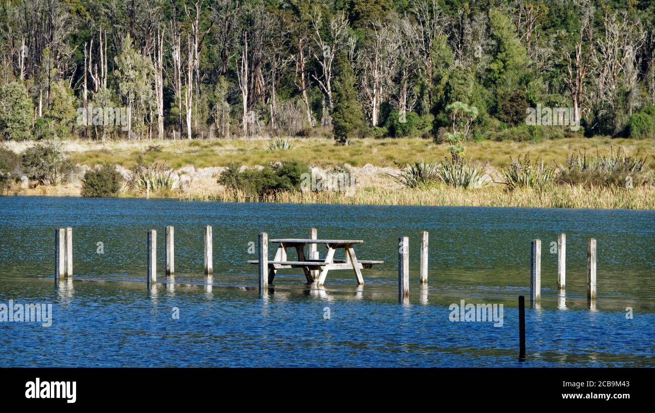 Picnic table on the submerged jetty on Lake Rotoroa, Nelson Lakes ...