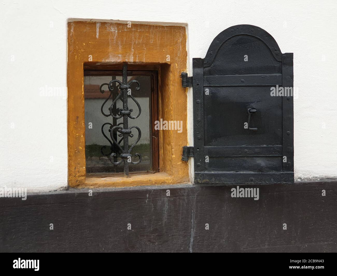 Opened small metallic shutter of basement window. Architecture detail ...