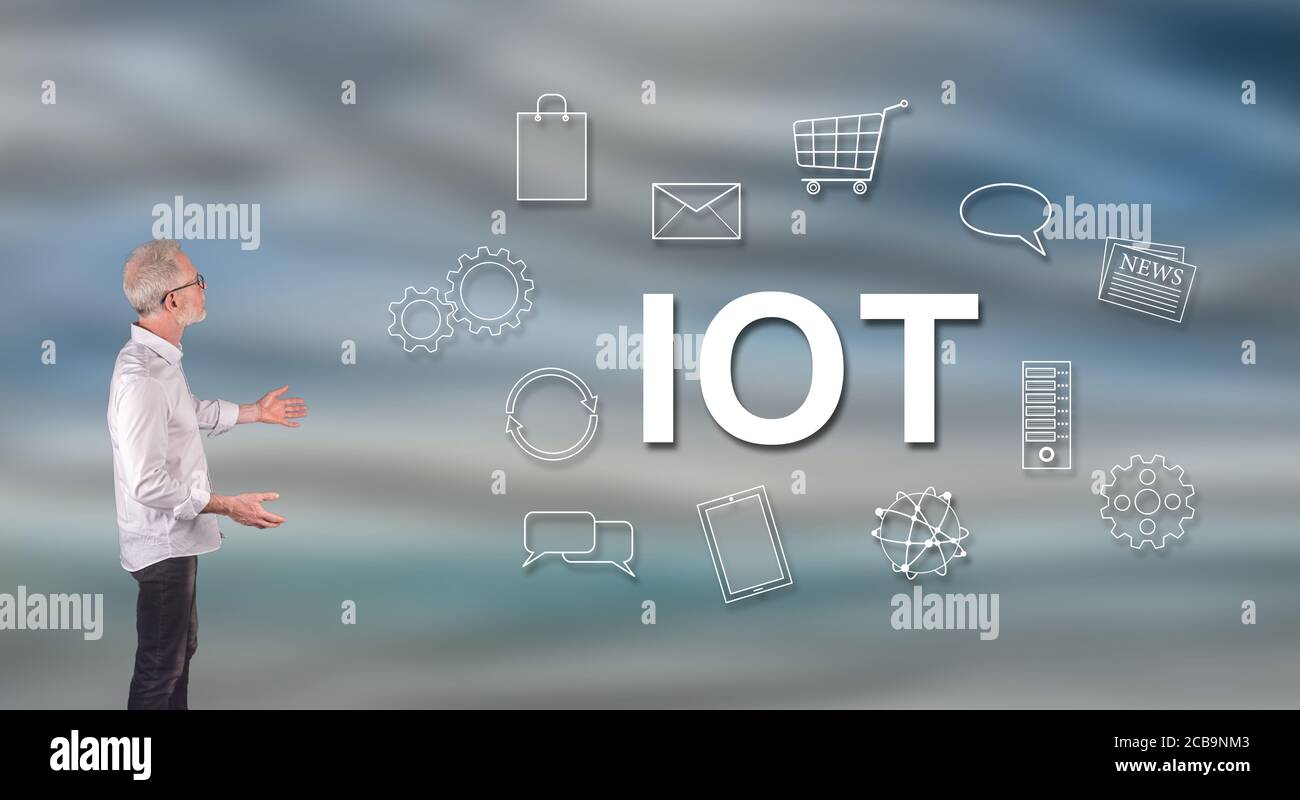 Businessman showing an iot concept on a wall screen Stock Photo - Alamy