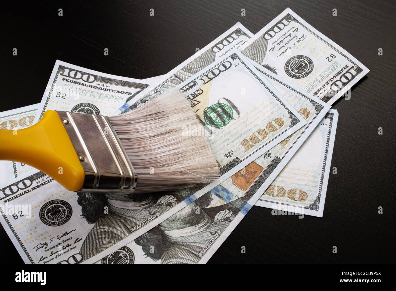Paint brush and dollar bill close up Stock Photo - Alamy