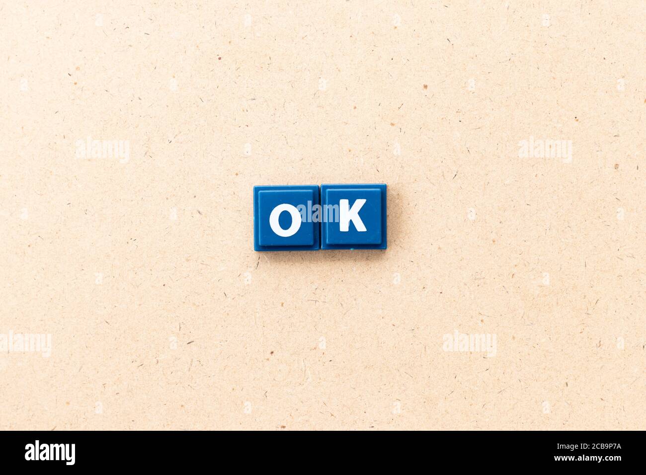Tile letter in word OK on wood background Stock Photo - Alamy