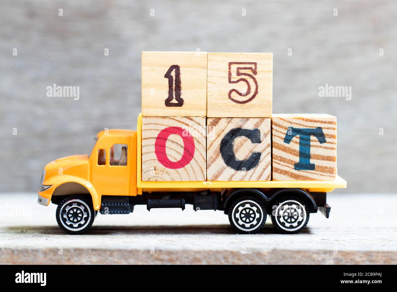 Truck hold letter block in word oct on wood background (Concept for ...