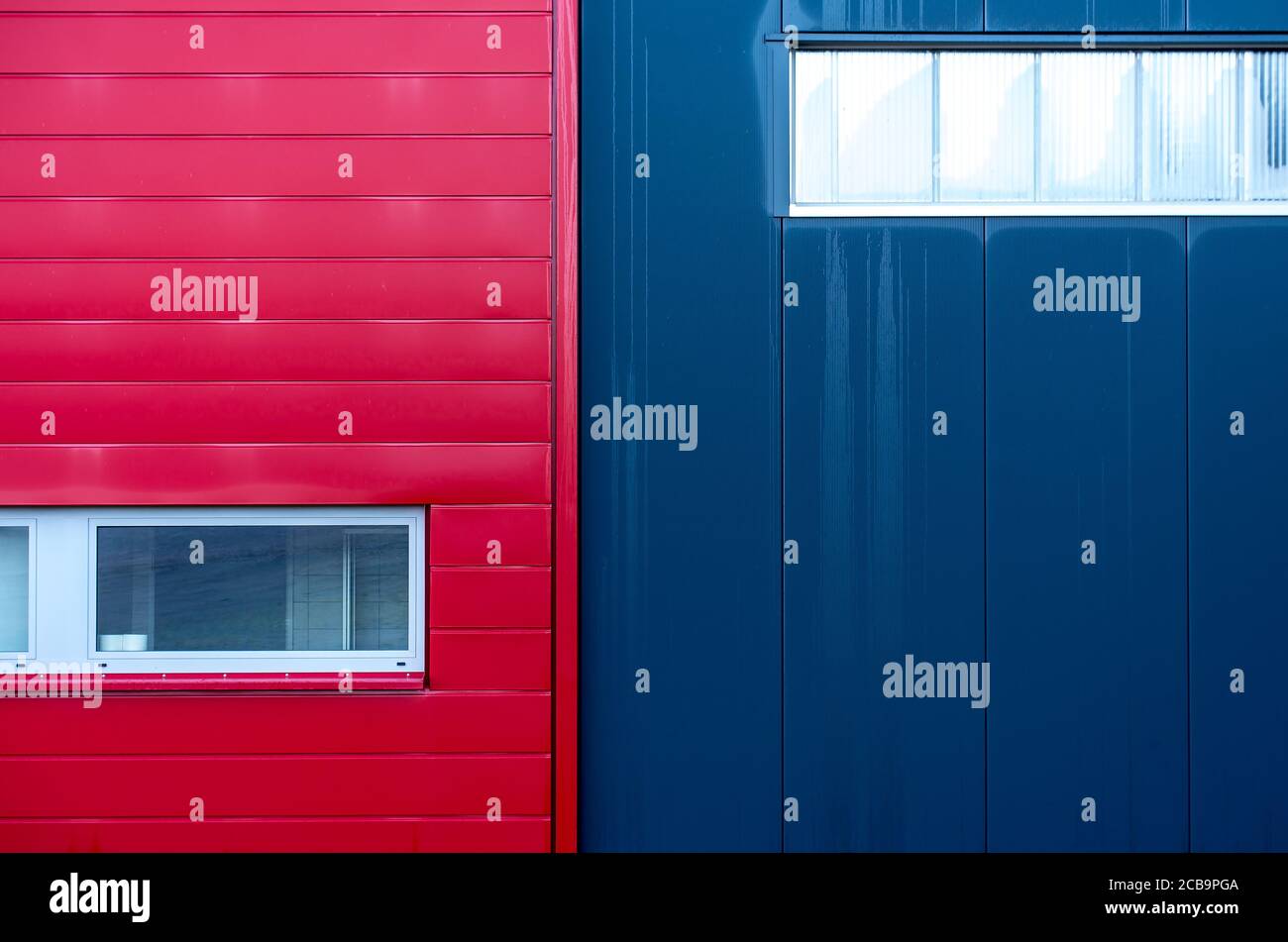 Closeup of a modern building with red and blue walls under the lights ...