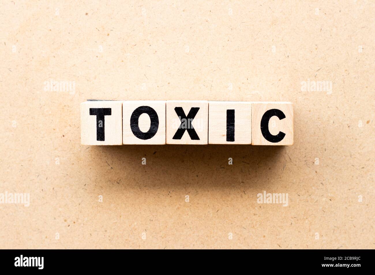 Letter block in word toxic on wood background Stock Photo - Alamy