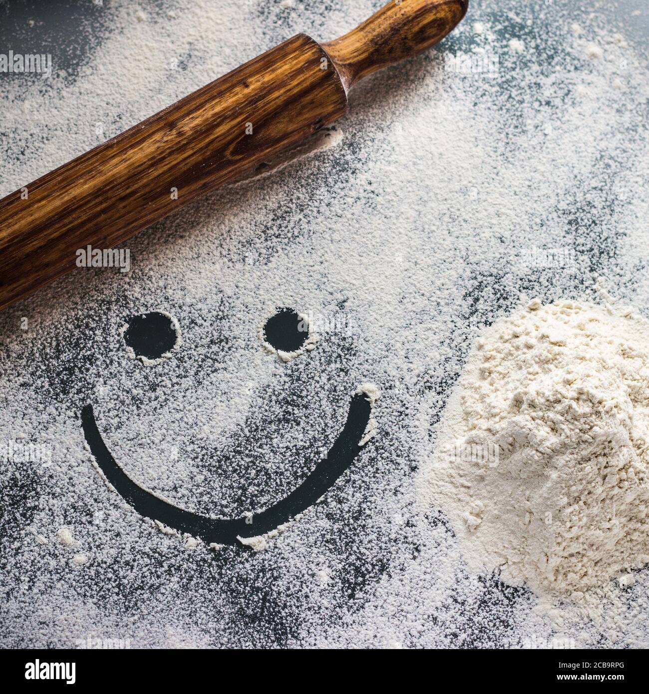 Top view of a smiling face pictured on sprinkled flour Stock Photo - Alamy