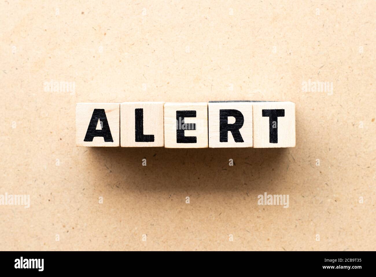 Letter block in word alert on wood background Stock Photo - Alamy