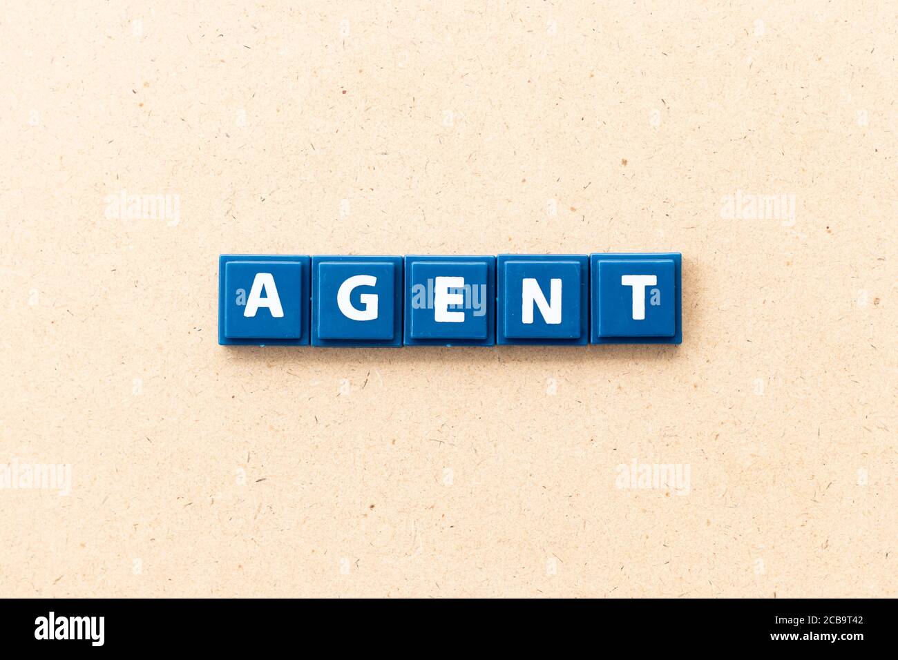 Tile letter in word agent on wood background Stock Photo - Alamy
